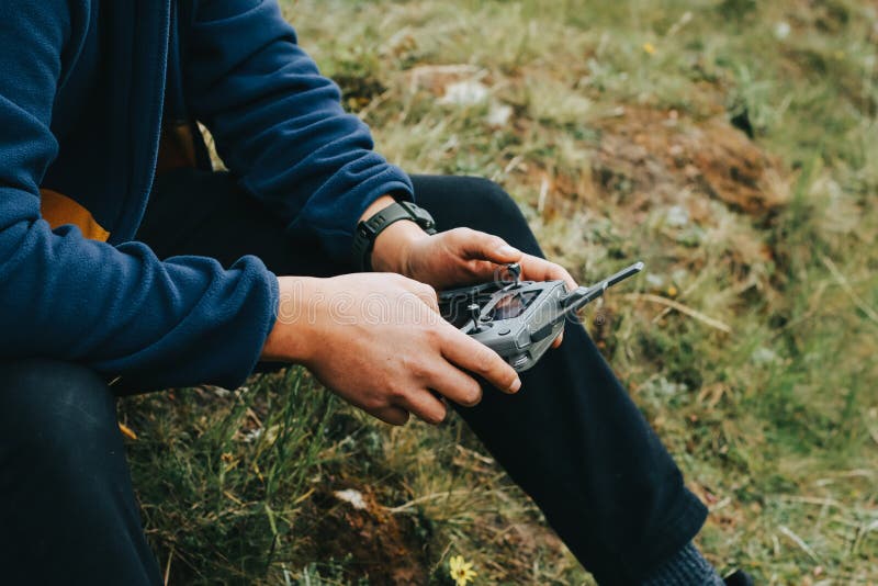 Man S Hands Holding the Remote Control of a Drone (Drone Operator ...