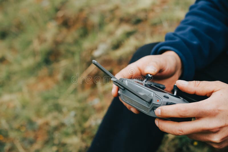 Man S Hands Holding the Remote Control of a Drone (Drone Operator ...