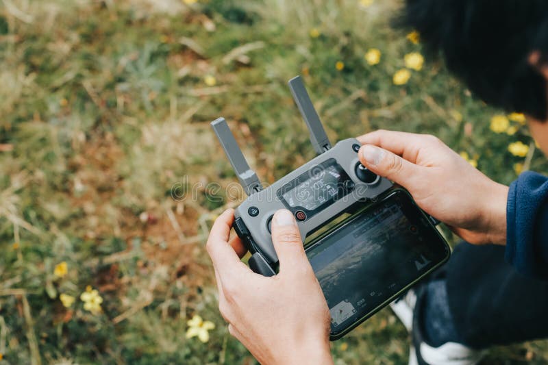Man S Hands Holding the Remote Control of a Drone (Drone Operator ...