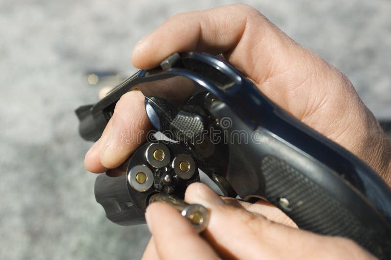 Man S Hands Loading Bullets into Gun Stock Photo - Image of equipment ...
