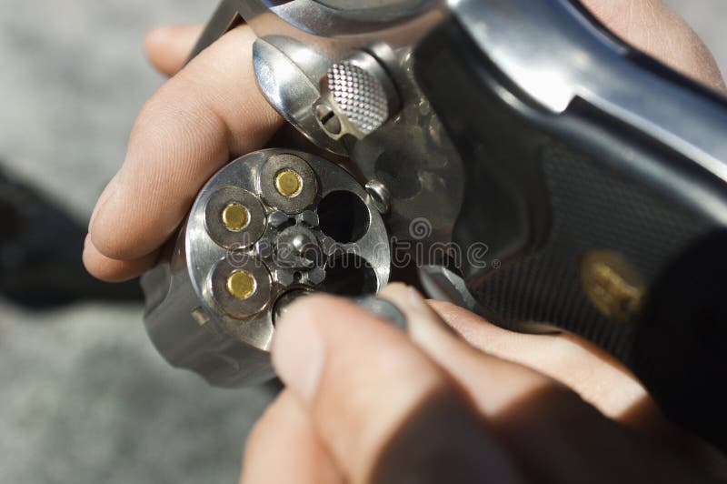 Man S Hands Loading Bullets into Gun Stock Photo - Image of metal ...