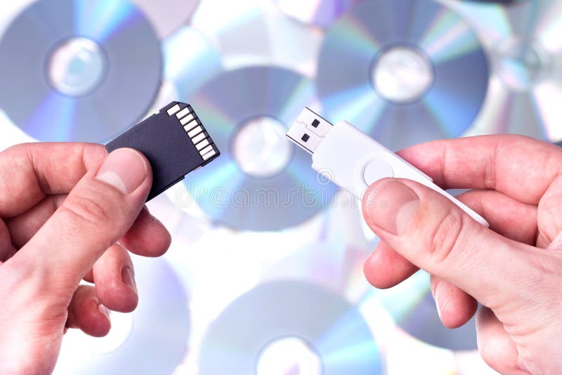Man S Hands with SD Card and Pendrive Over CD S Background. Stock Image ...