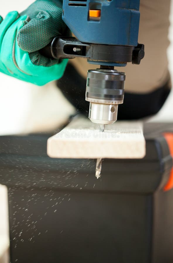Man s hands using a drill stock image. Image of equipment - 43415639
