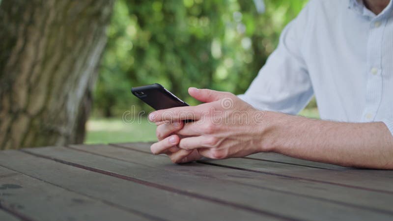 Man`s Hands Using a Phone in the Park Stock Photo - Image of summer ...