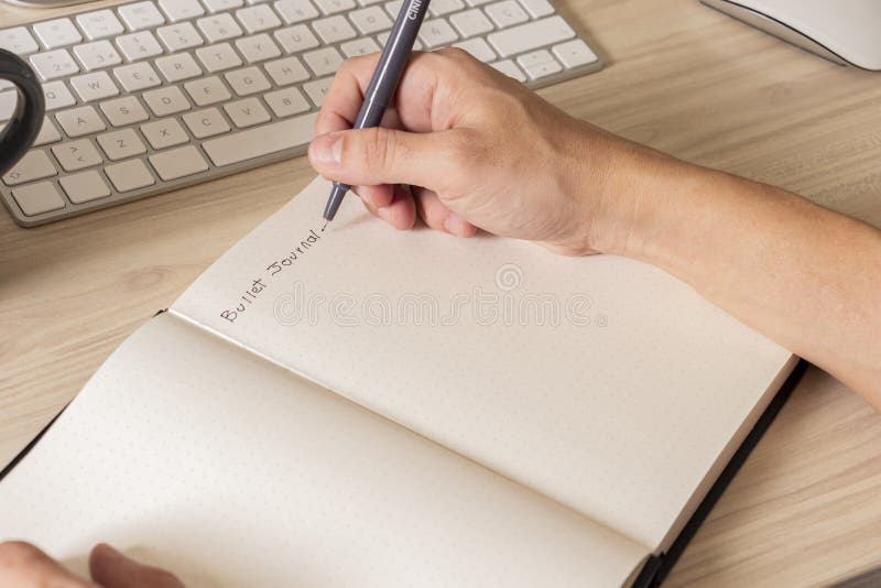 Man S Hands Writing in His Bullet Journal with a Pen Stock Photo ...