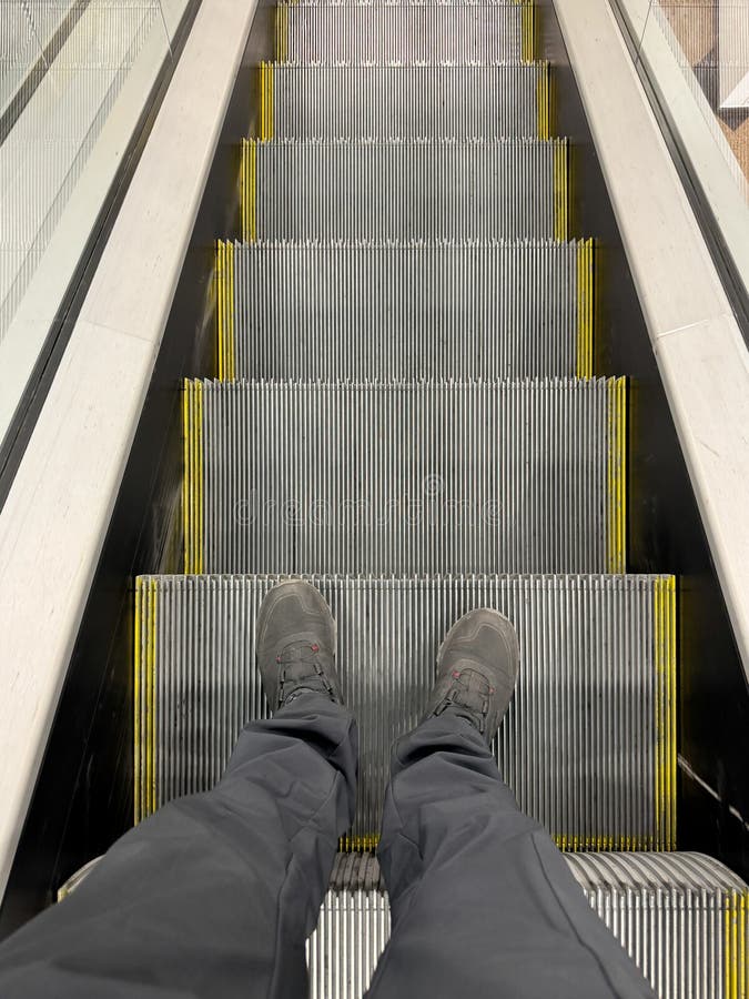 A Man& X27;s Legs on the Steps of an Escalator Stock Image - Image of ...