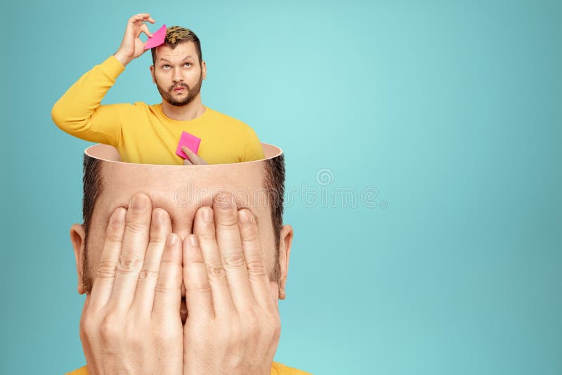 In the Man`s Open Head, the Brain Glues Stickers To Itself. the Concept ...