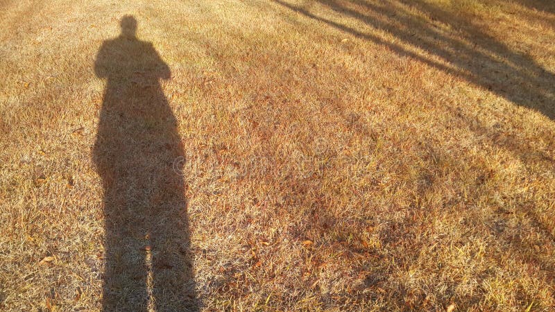 Man`s Shadow on a Brown Grass Playground with Sun Light Stock Photo ...