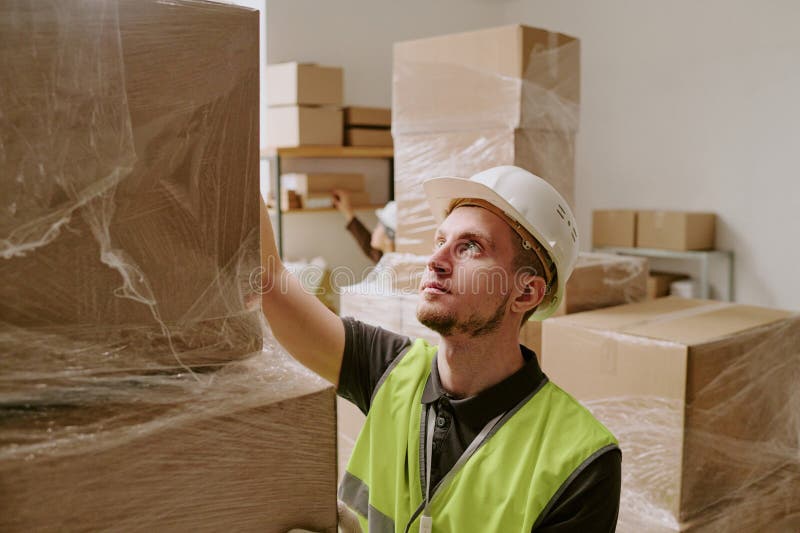 Inspecting Boxes in Warehouse with Hard Hat Stock Image - Image of ...