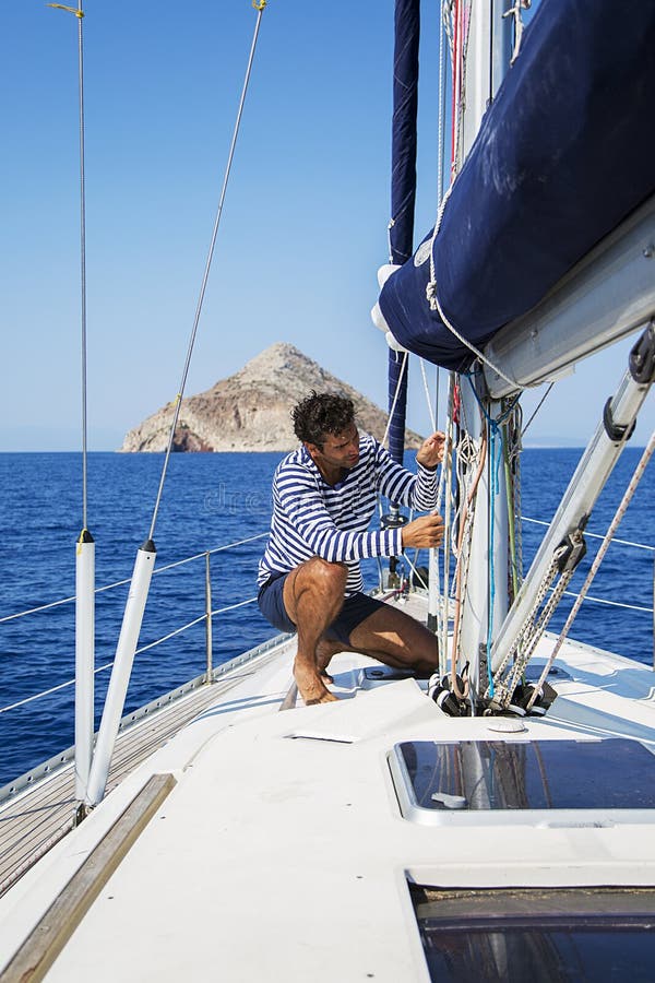 Man on sailboat stock image. Image of sailor, sunny, nautical - 78114875