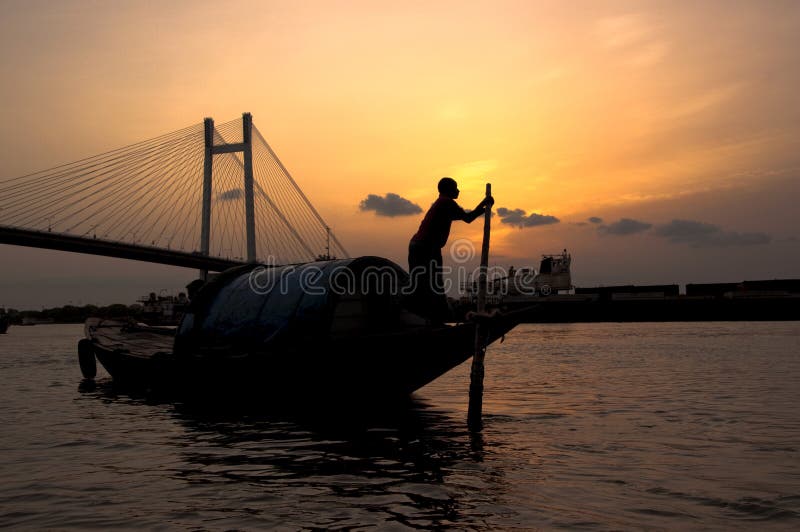 Man sailing boat at sunset stock image. Image of ganges - 41245133
