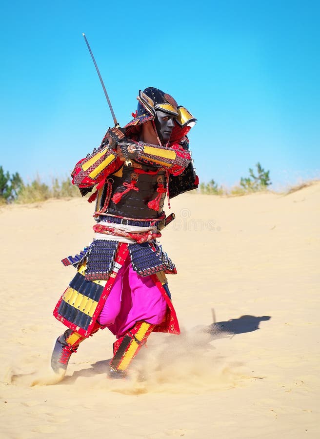 Man in Samurai Costume with Sword Running on the Sand. Stock Image ...