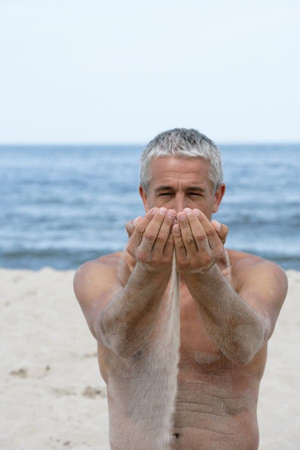 Man with sand in hands stock image. Image of handsome - 11076593