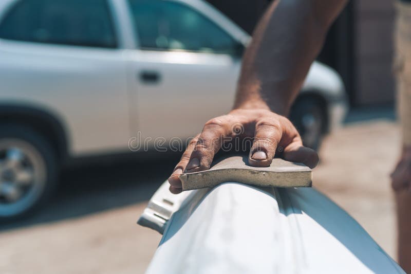 Man Sanding the Bumper from the Car. Car Maintenance and Repair in the ...