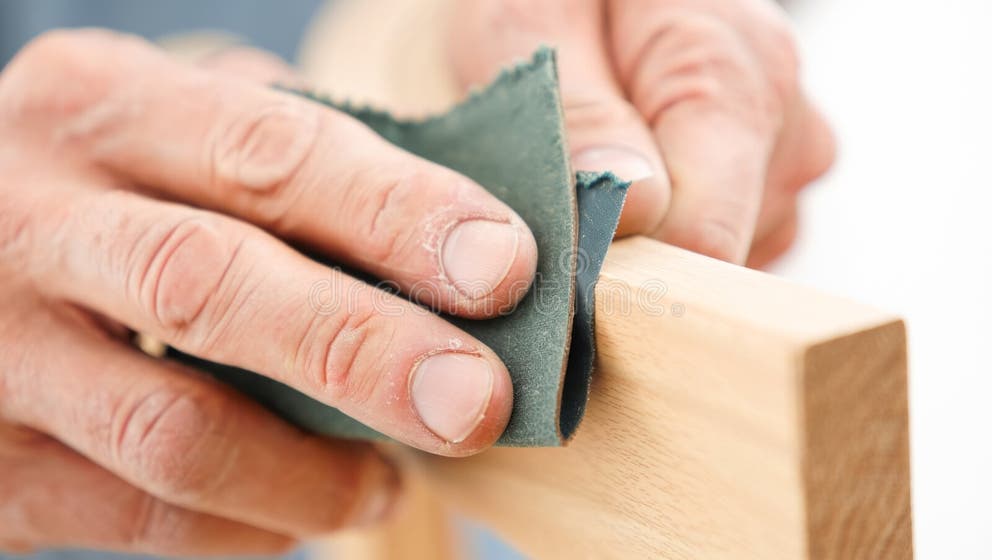 Man is Sanding a Piece of Wood with a Piece of Sandpaper Stock Photo ...