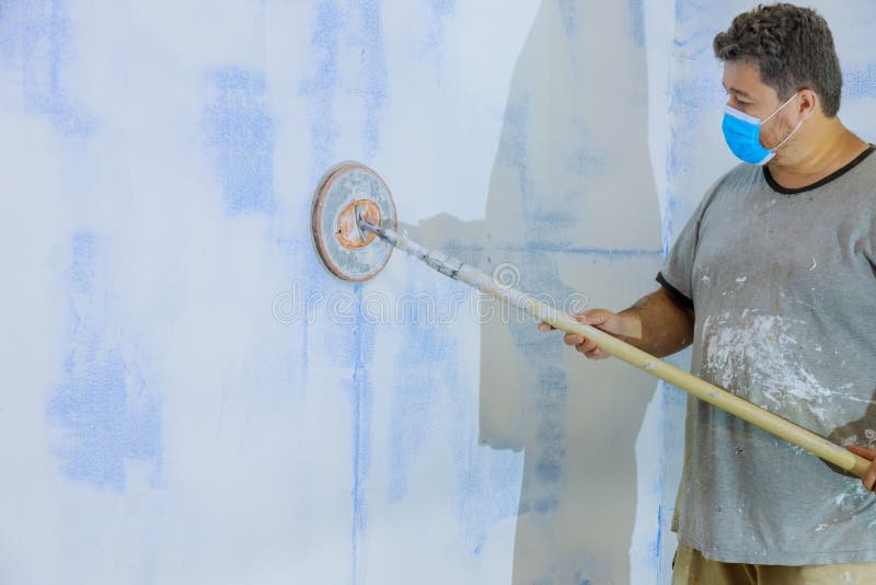 Man Sanding the Plaster Plasterboard in Drywall Stock Image - Image of ...