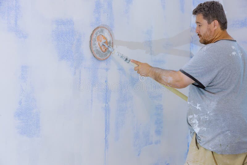 Man Sanding the Plaster Plasterboard in Drywall Stock Photo - Image of ...