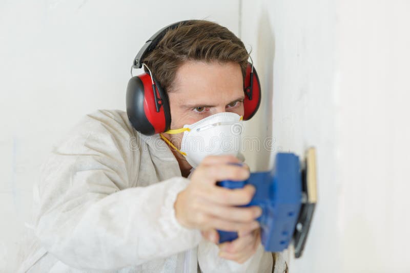 Man sanding wall stock image. Image of sand, contractor - 265994305