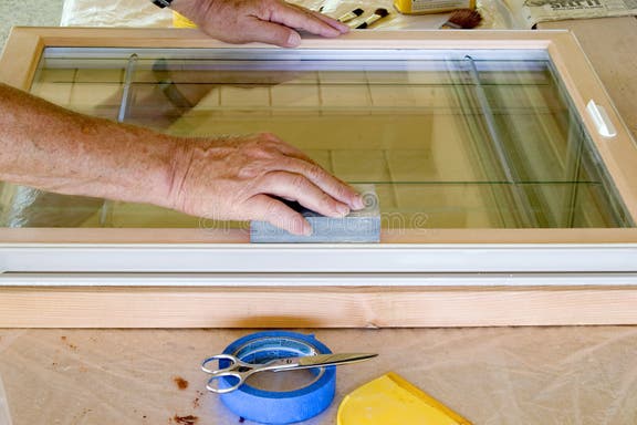 Man Sanding Window Frame stock photo. Image of project - 1090040
