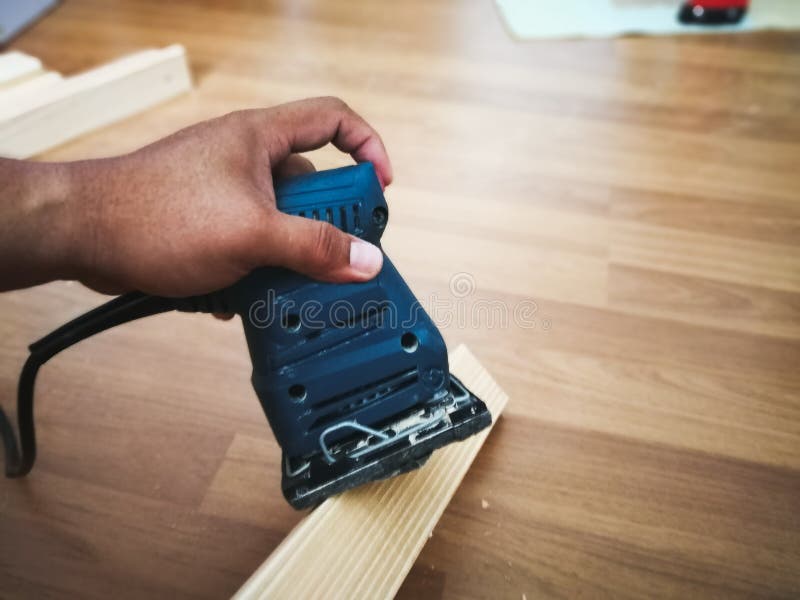 Man Sanding Wood with Square Sander in a Workshop. Stock Photo - Image ...