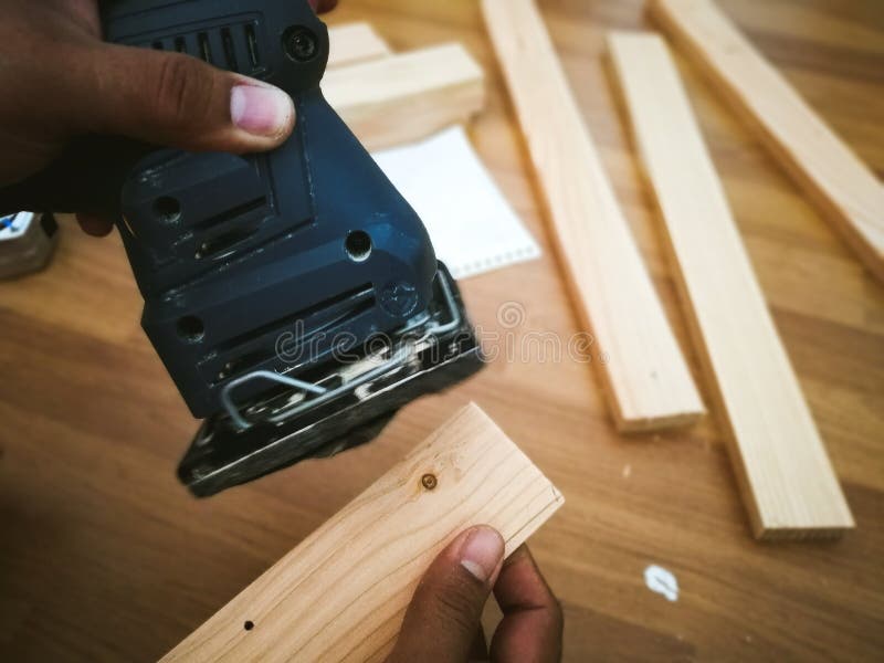 Man Sanding Wood with Square Sander in a Workshop. Stock Image - Image ...