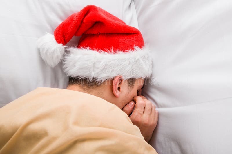 Man in Santa Hat sleeping stock photo. Image of room - 161582356