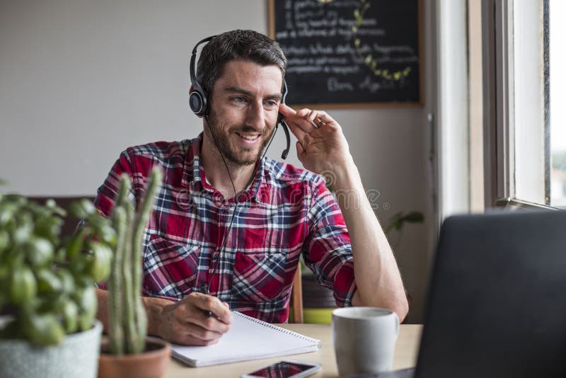 Man Working from Home in Conference Call with Colleagues Using Headset ...