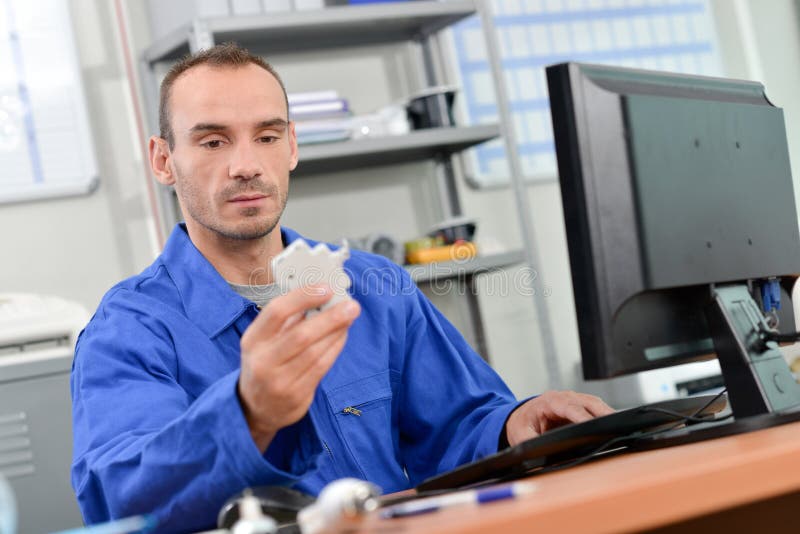 Man Sat in Front Computer Holding Electrical Component Stock Photo ...