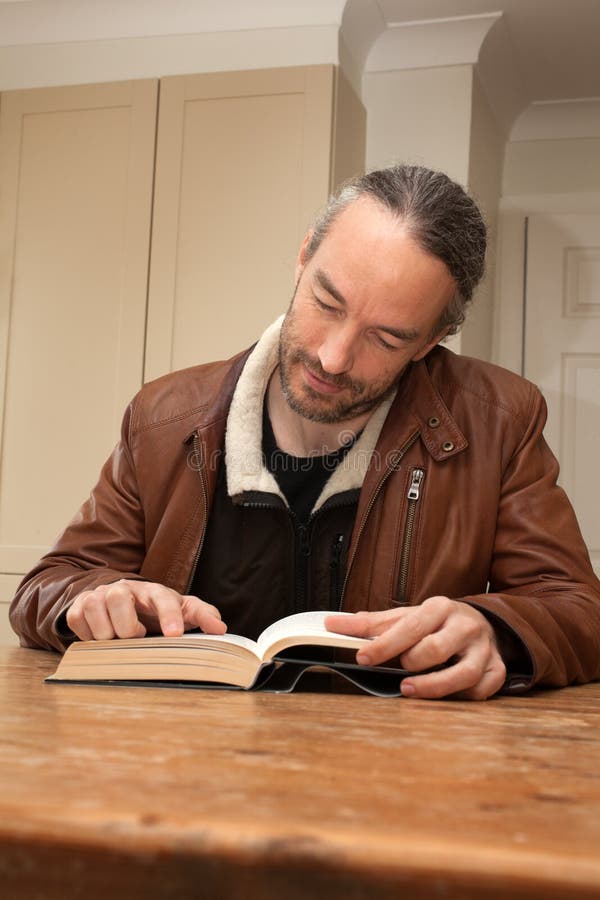 A man sat reading a book stock photo. Image of hair - 179474034