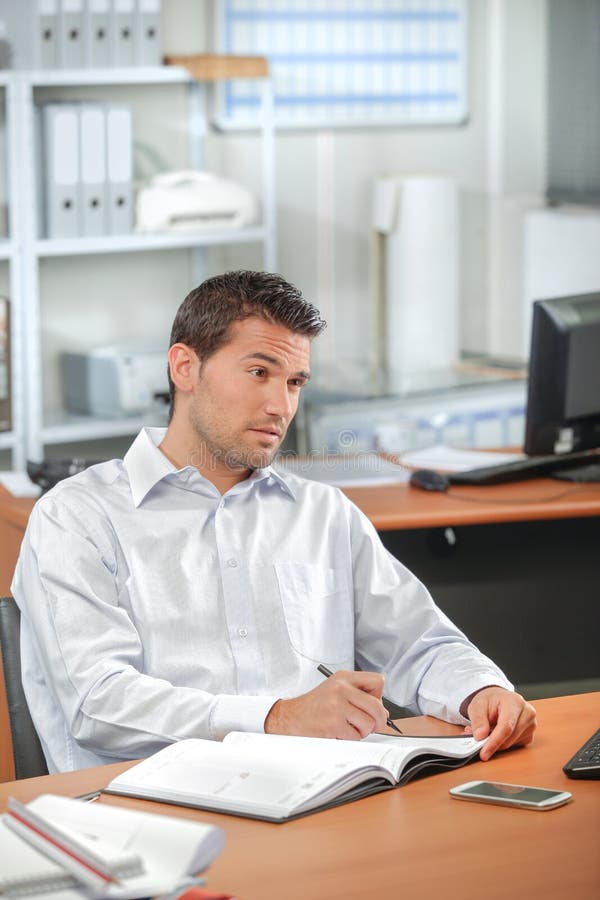 Writing at desk in office stock photo. Image of adult - 172820740