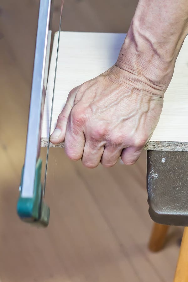 Man Sawing a Board with a Hacksaw Stock Image - Image of wood ...