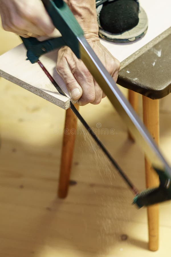 Man Sawing a Board with a Hacksaw Stock Image - Image of tool, wood ...