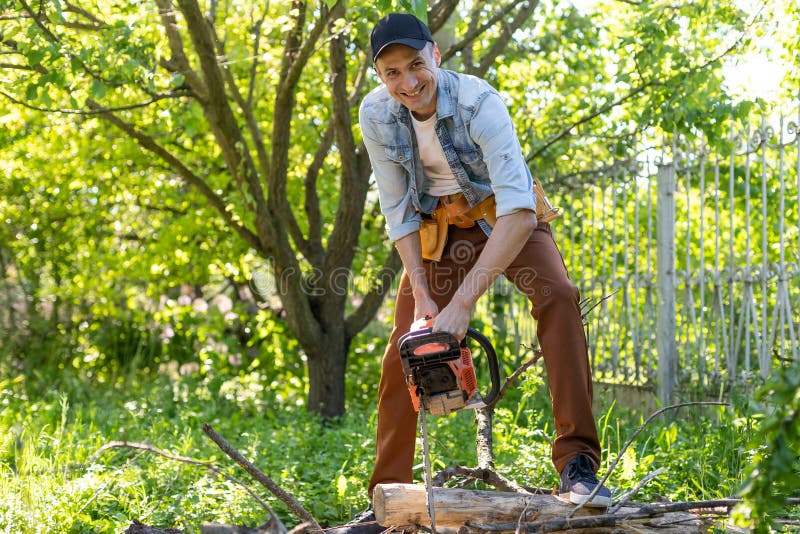 Man Sawing Branches with a Chainsaw. Concept of a Professional Logging ...