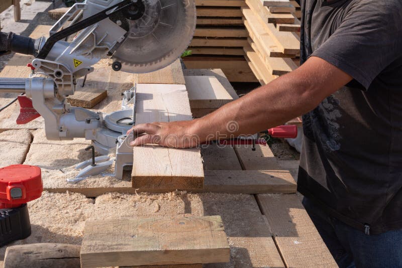 Man sawing a wood board stock photo. Image of machine - 132848362