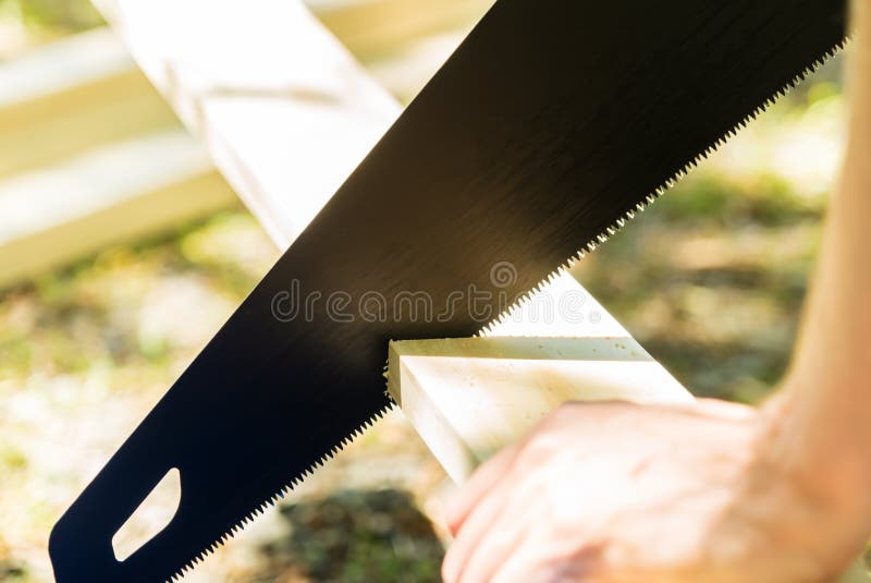 Man Sawing a Wood Board Outdoors Stock Photo - Image of tool, trade ...