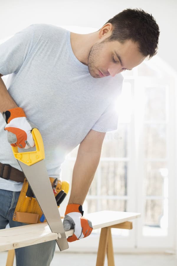 Man Sawing Wood in New House Stock Image - Image of ethnicity, adult ...