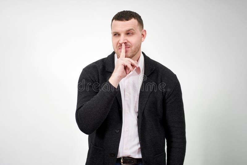 Man Saying Hush and Be Quiet with Finger on Lips Gesture Looking at ...