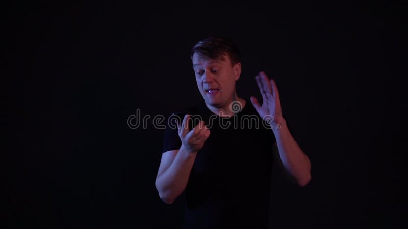 The Man Says Bye Bye Goodbye on the Phone and Runs on Black Background ...