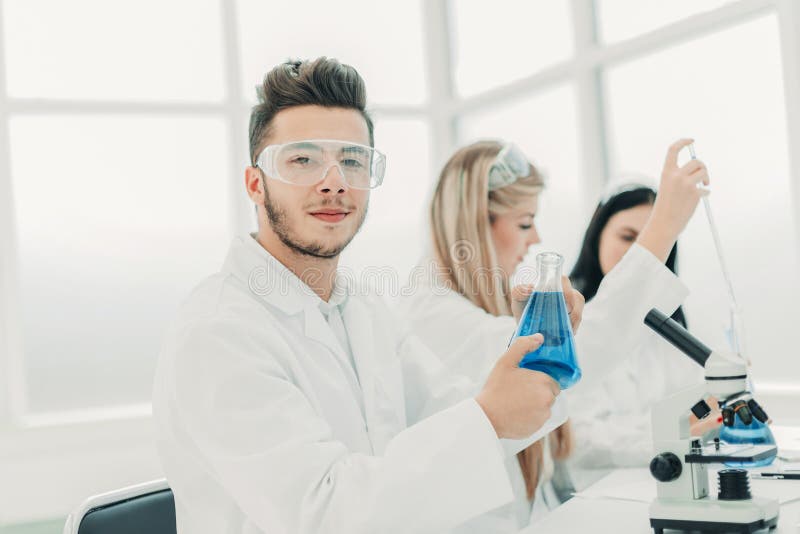Man Scientist Holding a Flask of Liquid for the Experiment Stock Image ... Man Scientist Holding a Flask of Liquid for the Experiment Stock Image ...