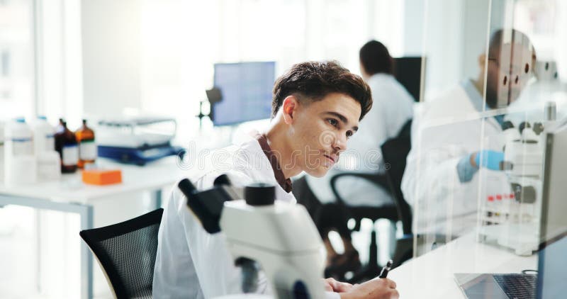 Man, Scientist and Notes with Computer in Lab of Medical Research ...