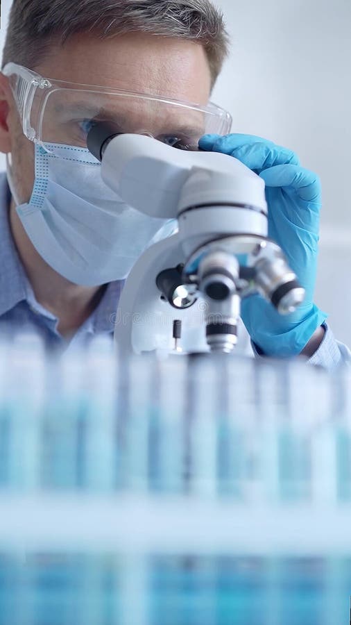 Man Scientist with Protective Glasses, Mask and Gloves is Using Stock ...