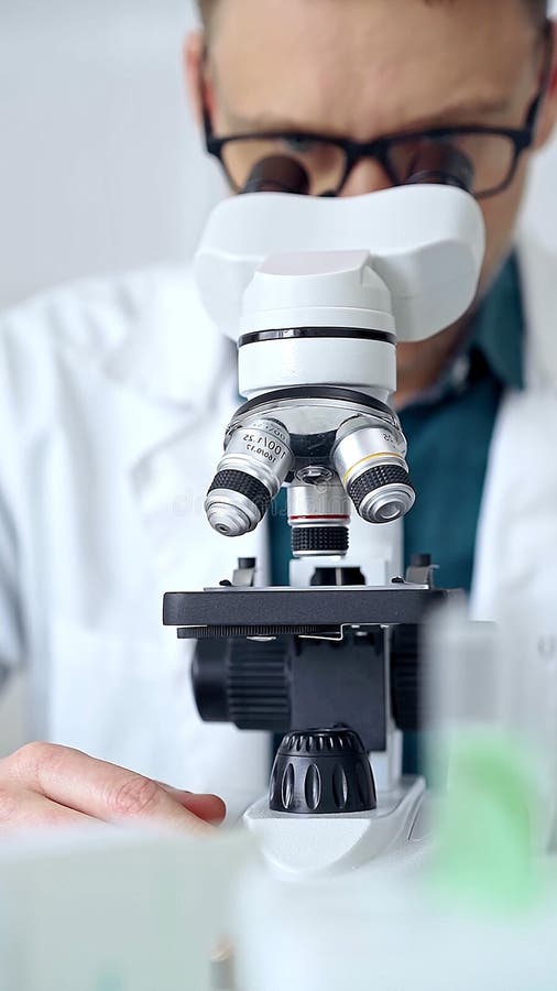Man Scientist Using Microscope in Laboratory. Microbiology Science ...