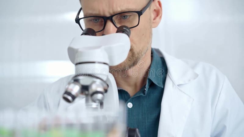 Man Scientist is Using Microscope in Laboratory. Microbiology Science ...