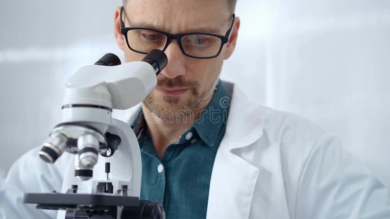 Man Scientist is Using Microscope in Laboratory. Microbiology Science ...