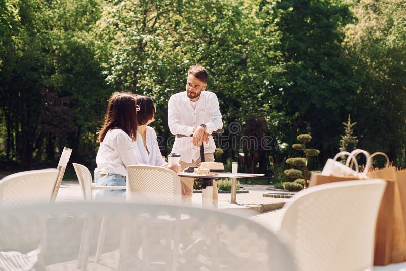 Man is with a Scooter. Three Friends Having Great Weekend Outdoors ...