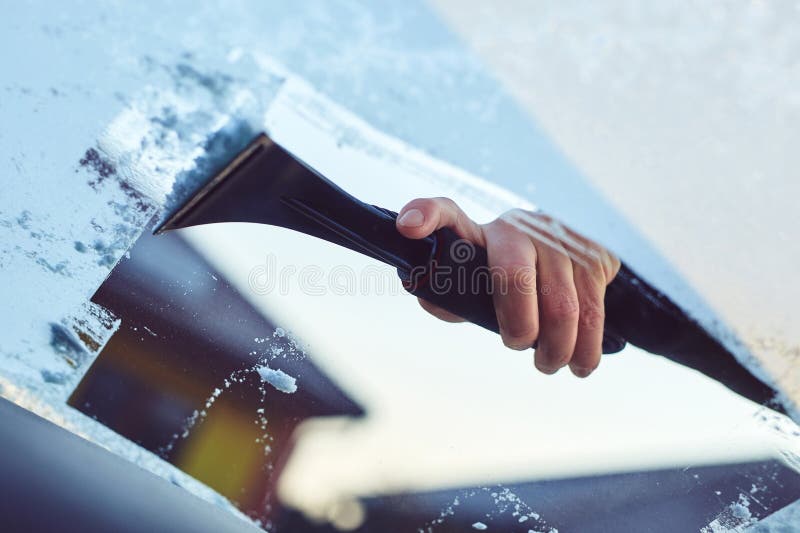 A Man Scratches the Front Window of His Car on a Cold Winter Morning ...