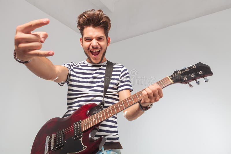 Man Screaming while Playing Guitar and Looking Down Stock Photo - Image ...
