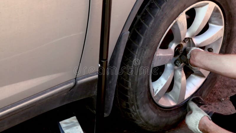 Man Up Nuts on Wheel with Lifting Jack Under Stock Video - Video of ...