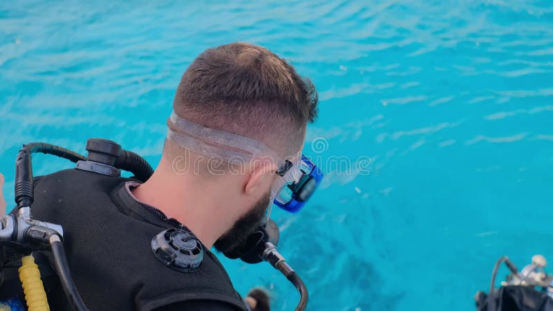A Man with Scuba Diving is Sitting on Board a Yacht, Preparing To Dive ...