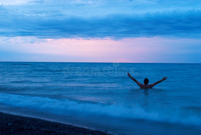 Man on the sea at sunset stock photo. Image of relaxation - 2978426